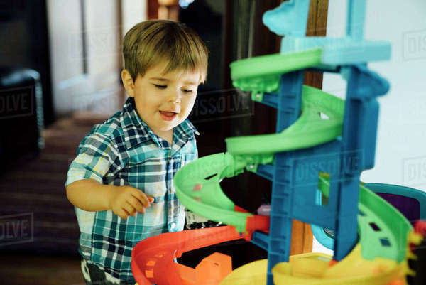 Boy playing with spiral track toy - Royalty-free Stock Photo | Dissolve