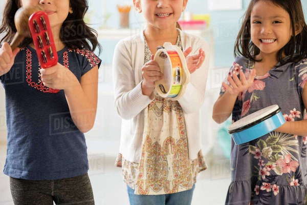 Girls playing music in school - Stock Photo - Dissolve