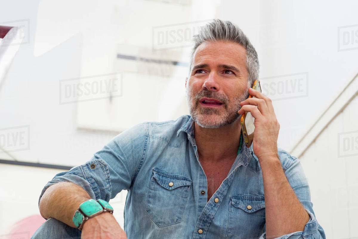 Caucasian man talking on cell phone - Stock Photo - Dissolve
