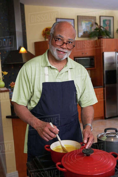 African man cooking dinner - Stock Photo - Dissolve