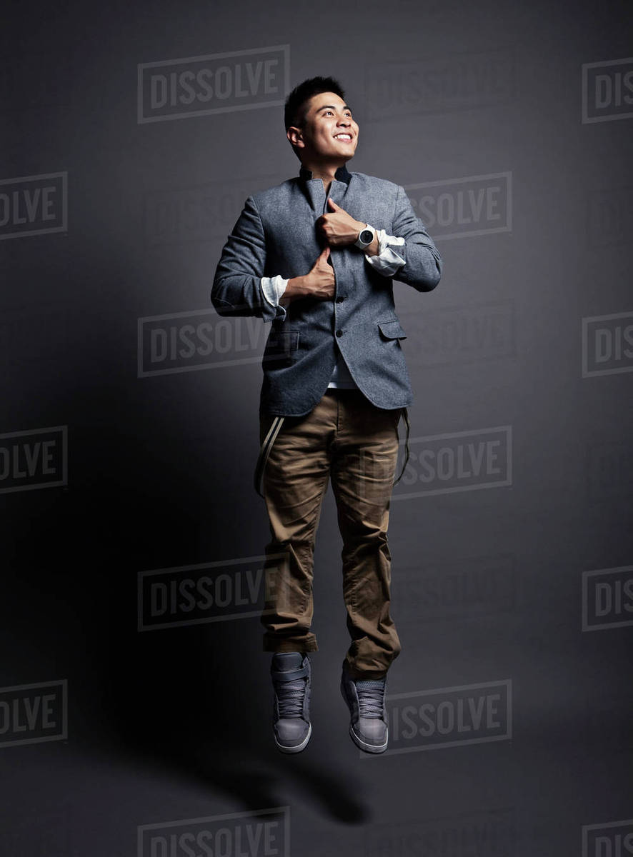Chinese man wearing jacket and jumping - Royalty-free Stock Photo ...