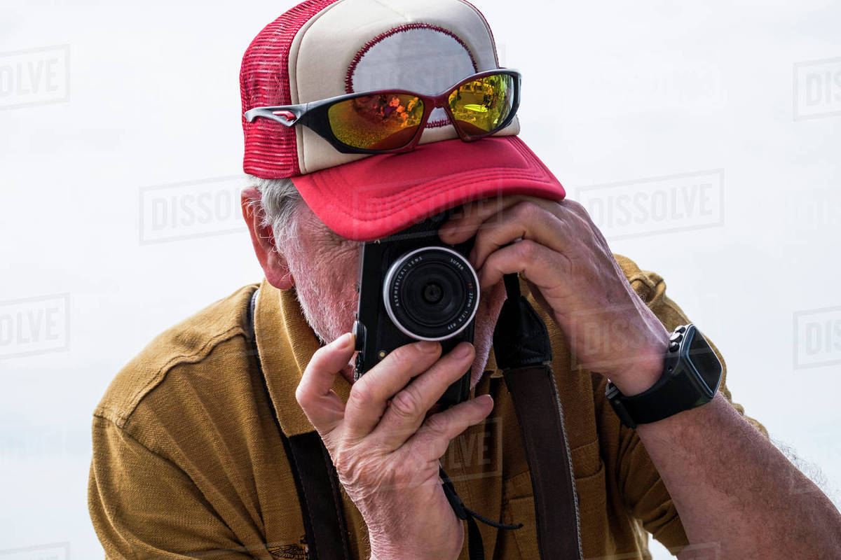 Man photographing with camera - Stock Photo - Dissolve