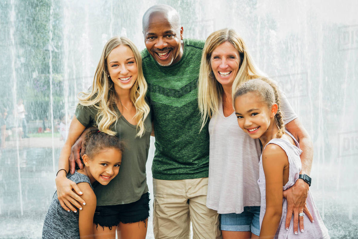 Multi-ethnic family posing near fountain - Royalty-free Stock Photo ...
