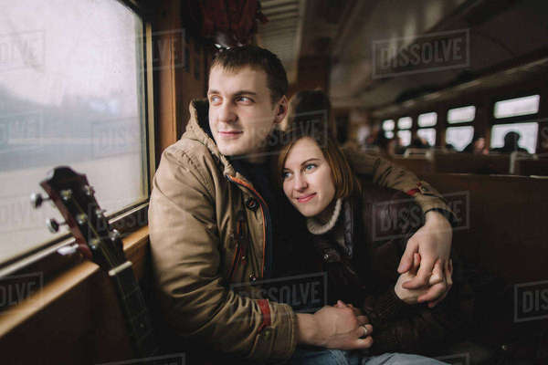 Couple hugging on train - Stock Photo - Dissolve