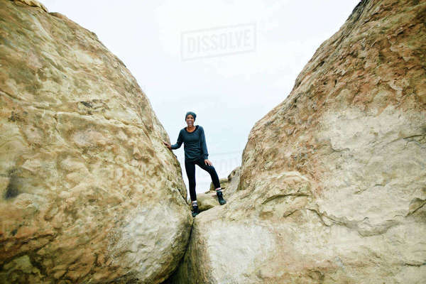 Portrait of smiling Black woman posing on rock formation - Royalty-free ...