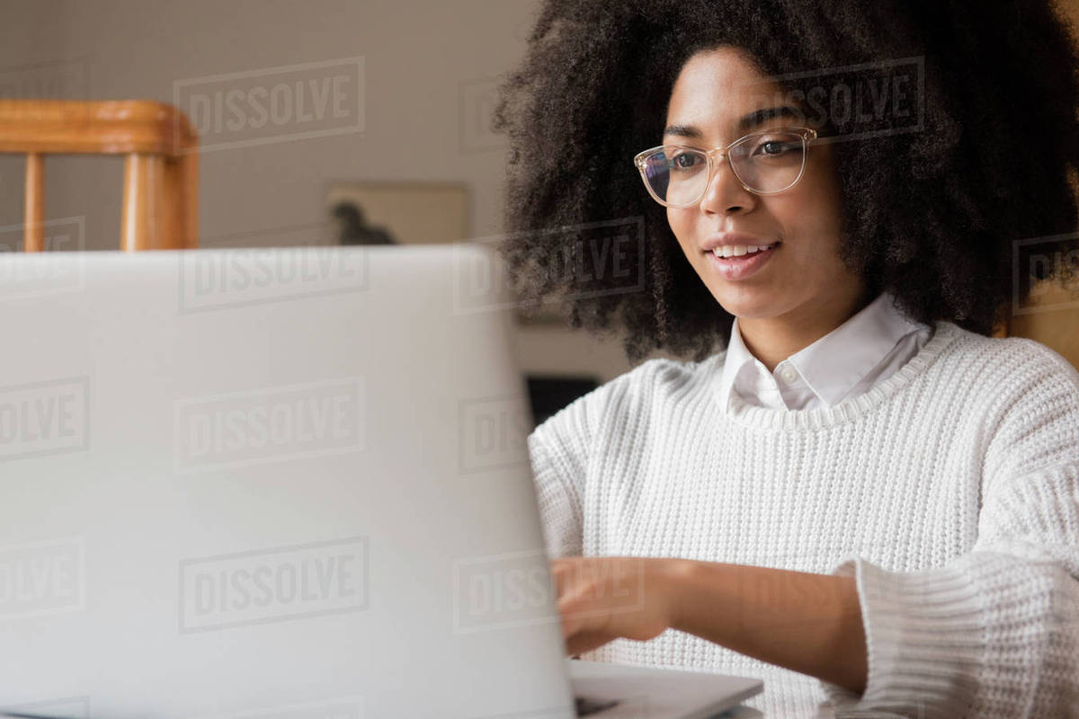 African American woman using laptop - Stock Photo - Dissolve