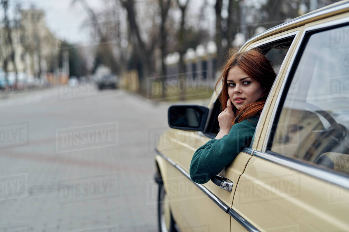 Caucasian woman driving car looking over shoulder - Royalty-free Stock ...