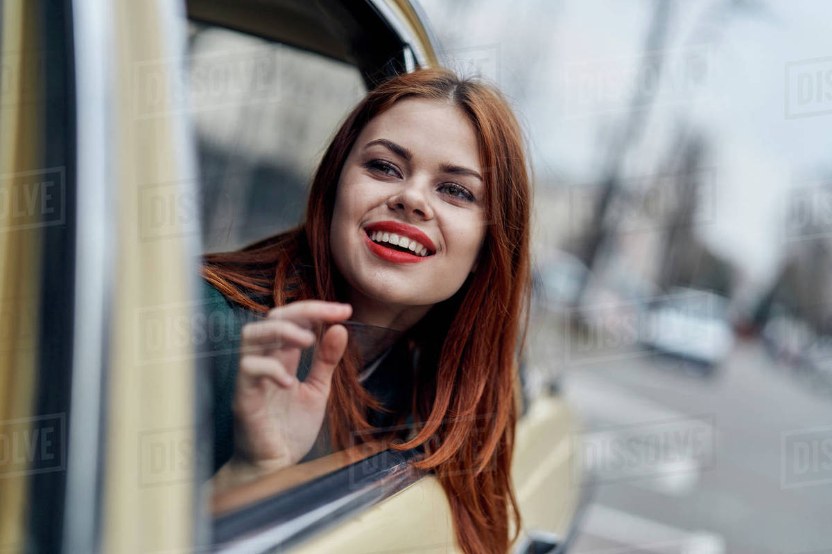 Smiling Caucasian woman in back seat of car - Royalty-free Stock Photo ...