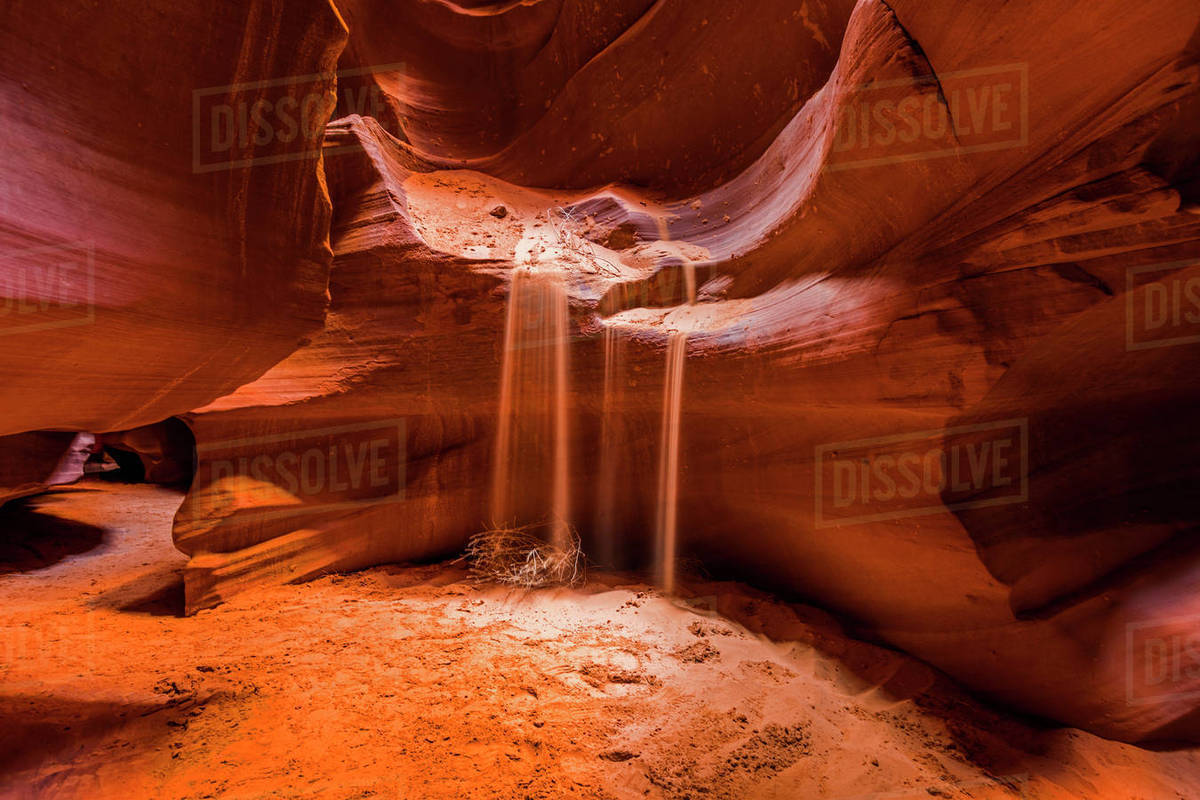 Sand pouring from wall of rock formation - Royalty-free Stock Photo ...