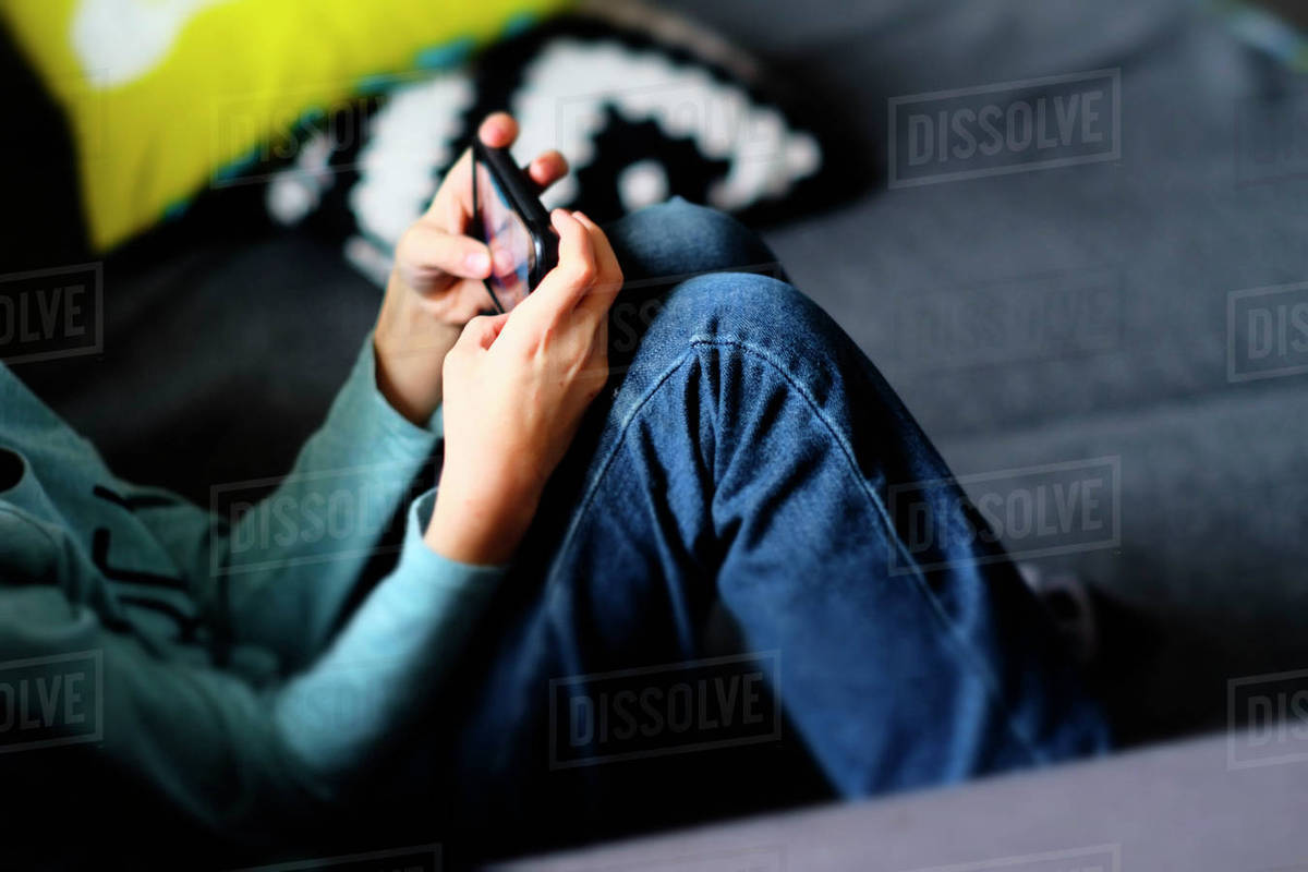 Close up of Caucasian boy playing with cell phone - Royalty-free Stock ...