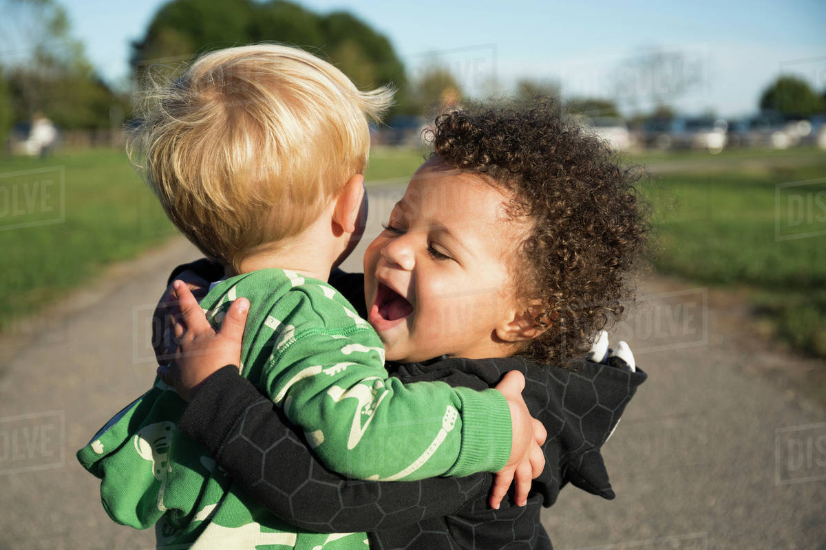 Happy baby boys hugging outdoors - Royalty-free Stock Photo | Dissolve