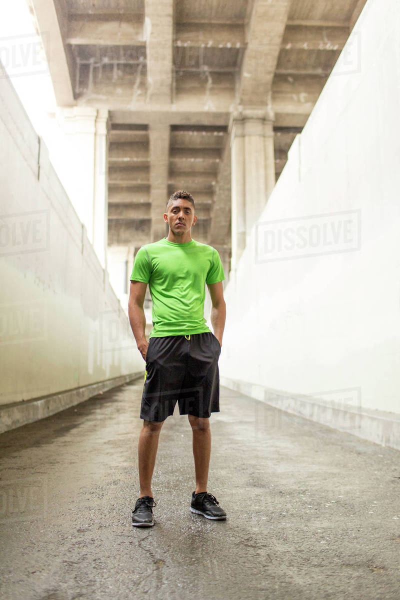 Serious Mixed Race man standing under bridge - Royalty-free Stock Photo ...