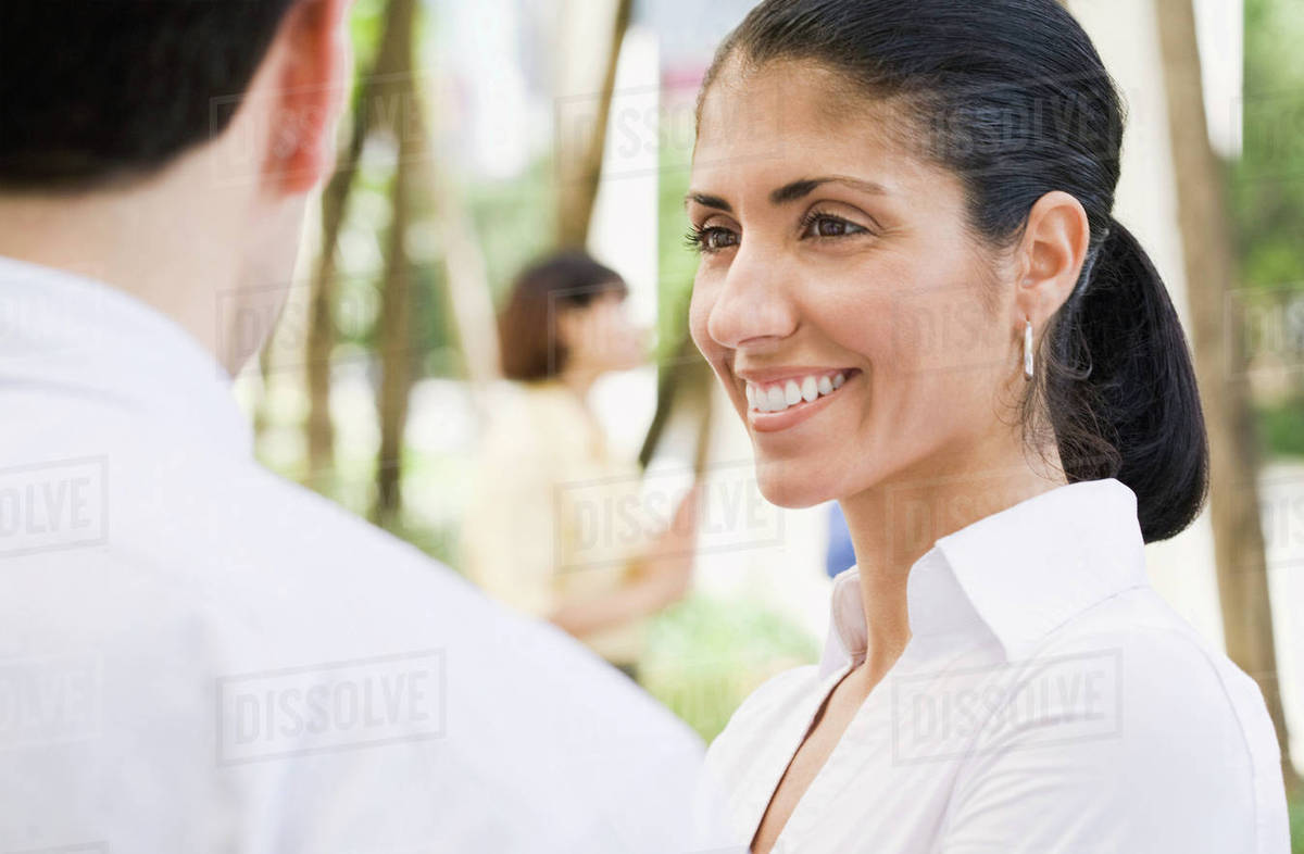 Smiling business people outdoors - Stock Photo - Dissolve