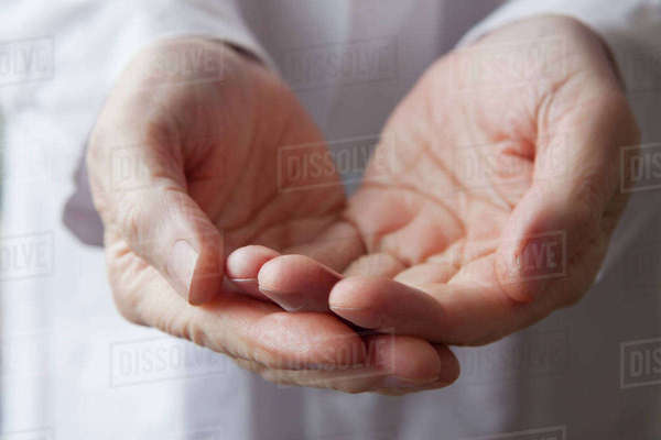 Cupped hands of Hispanic doctor - Royalty-free Stock Photo | Dissolve