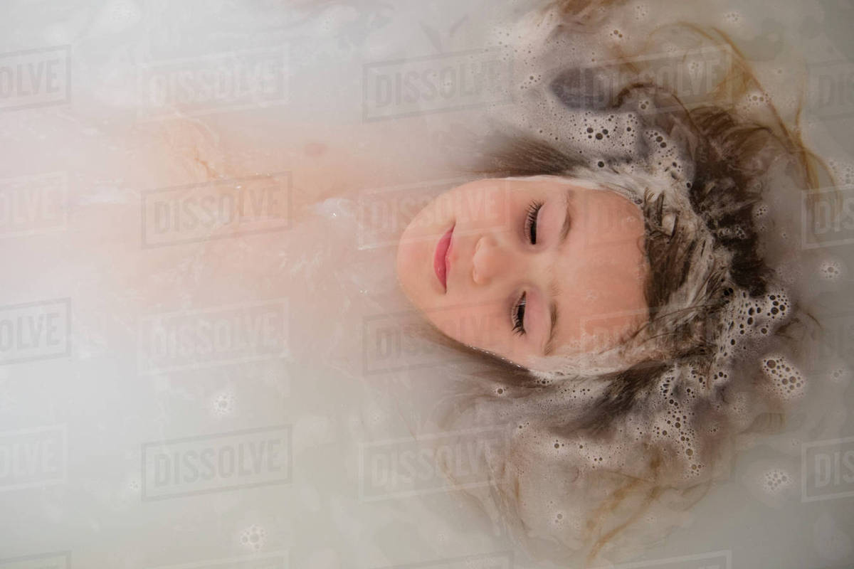 Face of Caucasian girl floating in bubble bath - Royalty-free Stock ...