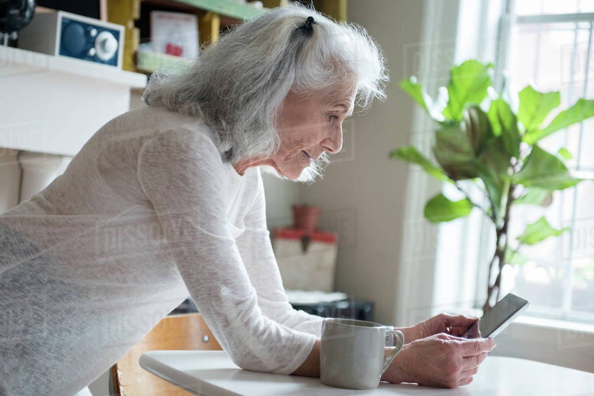 Older woman texting on cell phone - Royalty-free Stock Photo | Dissolve