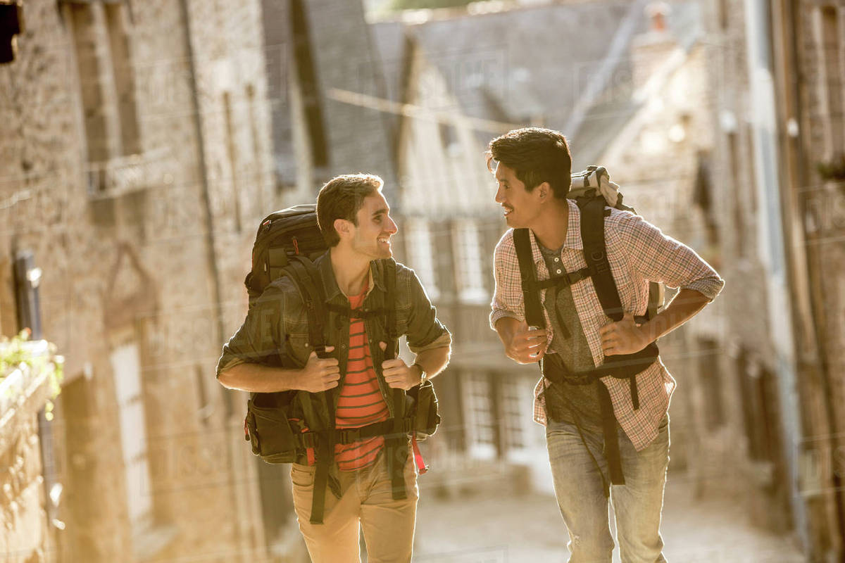 Men backpacking in city - Royalty-free Stock Photo | Dissolve
