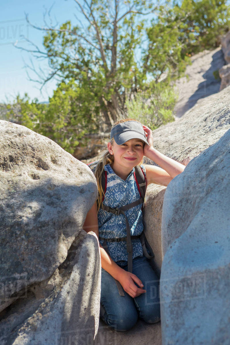 Portrait of Caucasian girl leaning on rock - Stock Photo - Dissolve