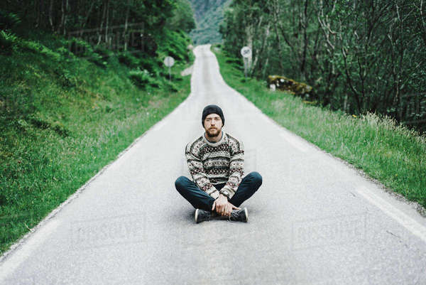 Caucasian man sitting in middle of road - Royalty-free Stock Photo ...