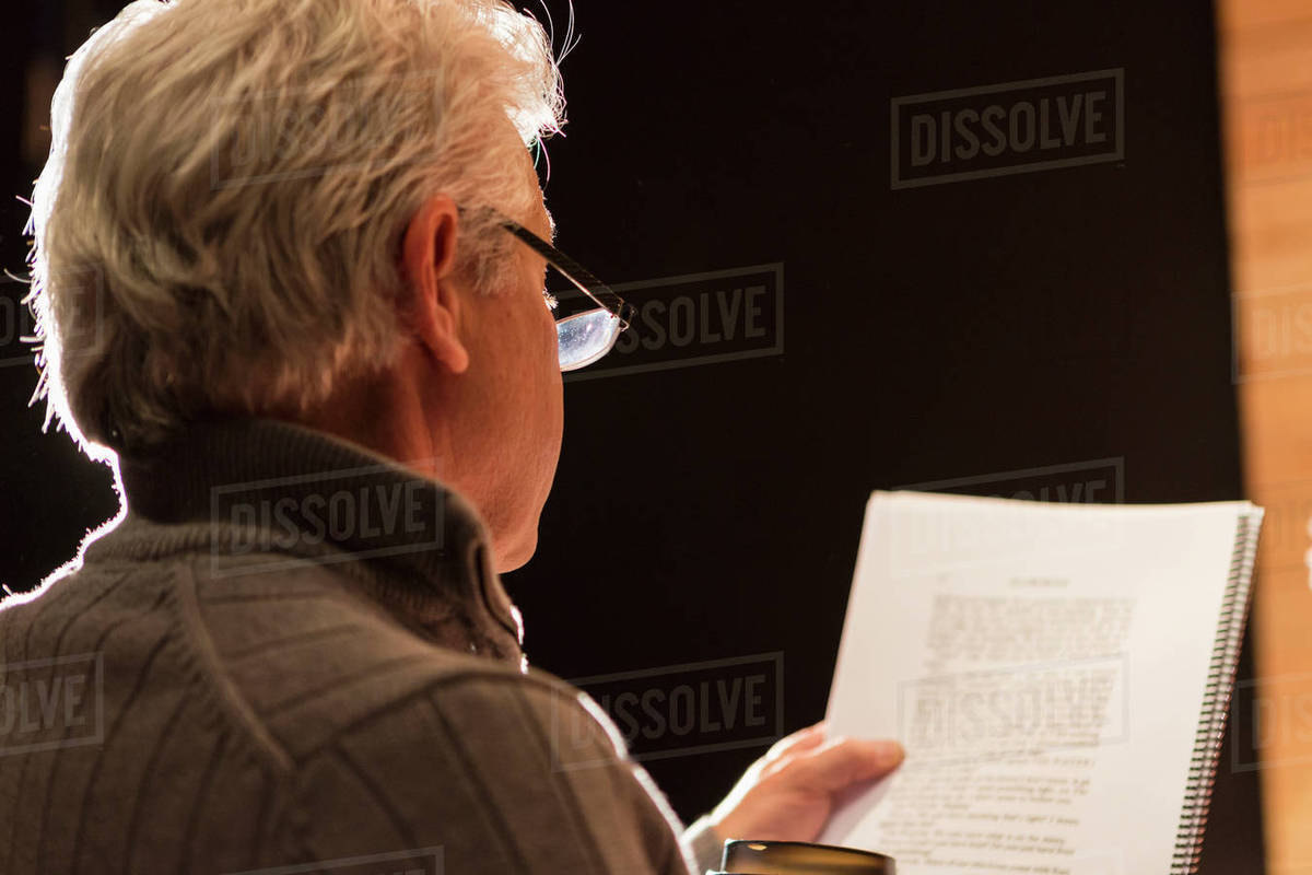 Hispanic man reading script in theater - Royalty-free Stock Photo ...