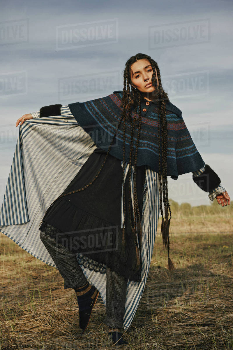 Caucasian woman wearing traditional clothing dancing in field - Royalty ...