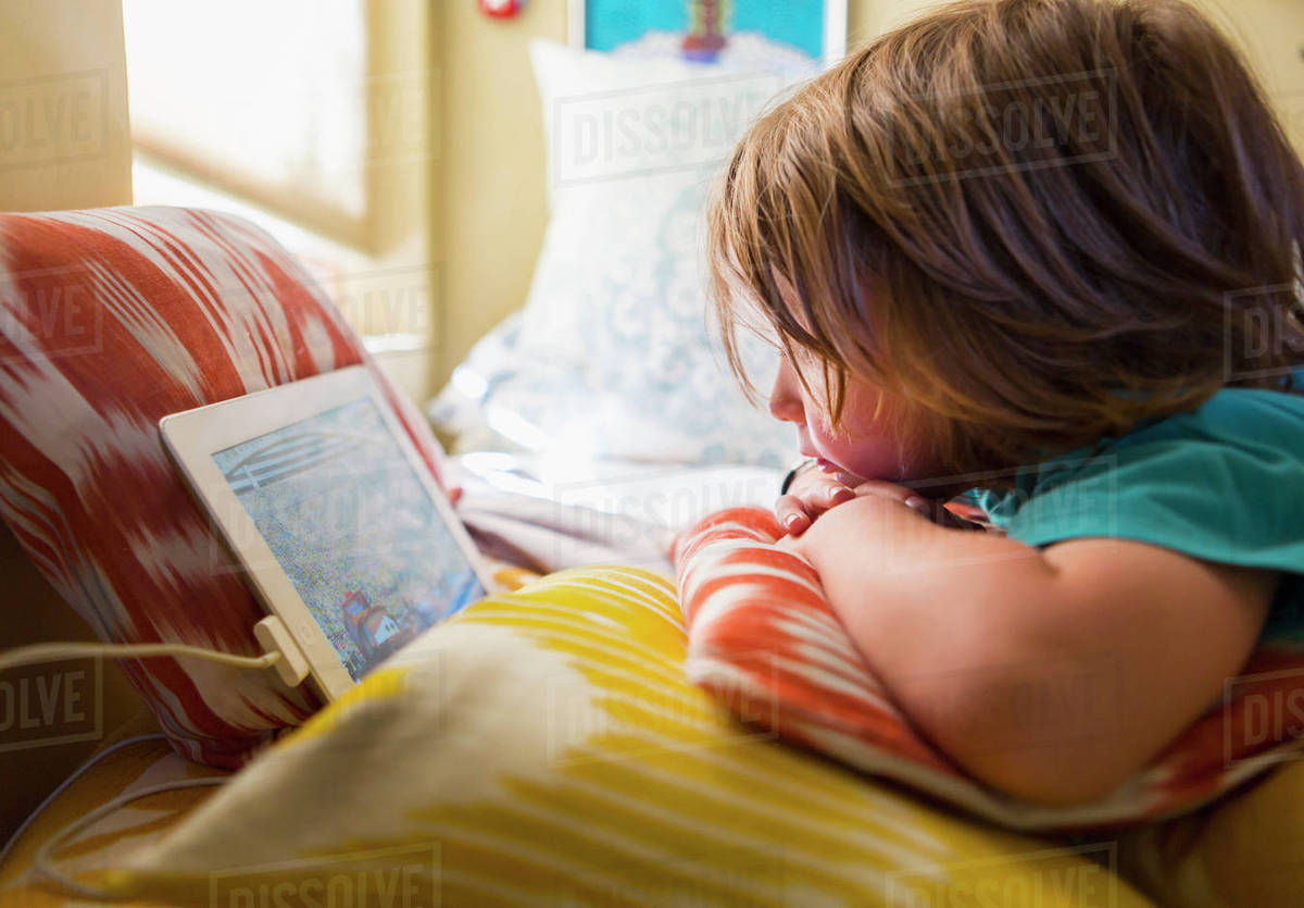 Caucasian boy watching digital tablet - Royalty-free Stock Photo | Dissolve