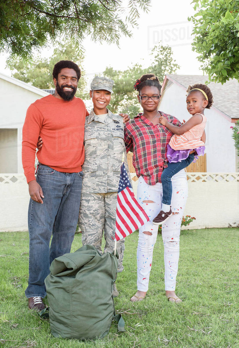 Portrait of black woman soldier with family - Stock Photo - Dissolve