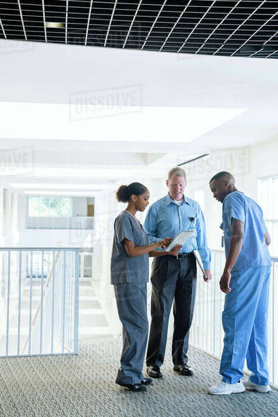 Doctor and nurses discussing digital tablet - Royalty-free Stock Photo ...