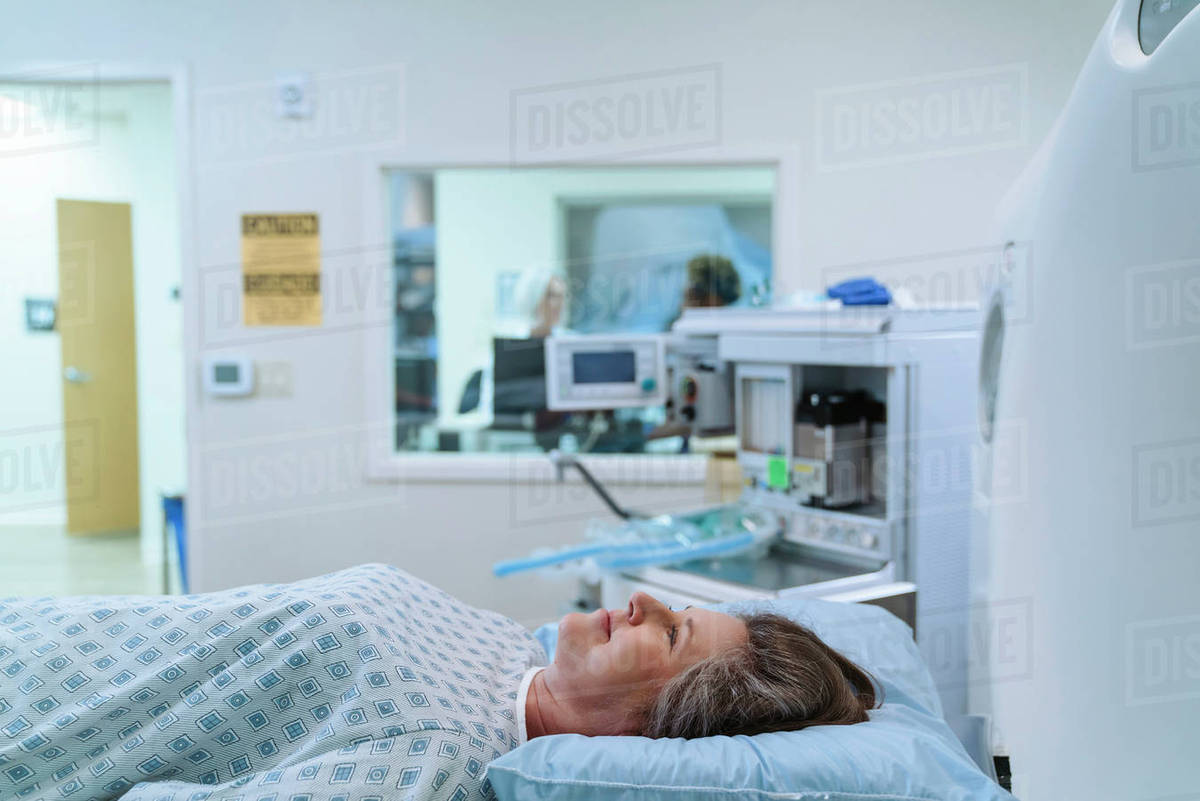 Caucasian patient laying at scanner - Royalty-free Stock Photo | Dissolve