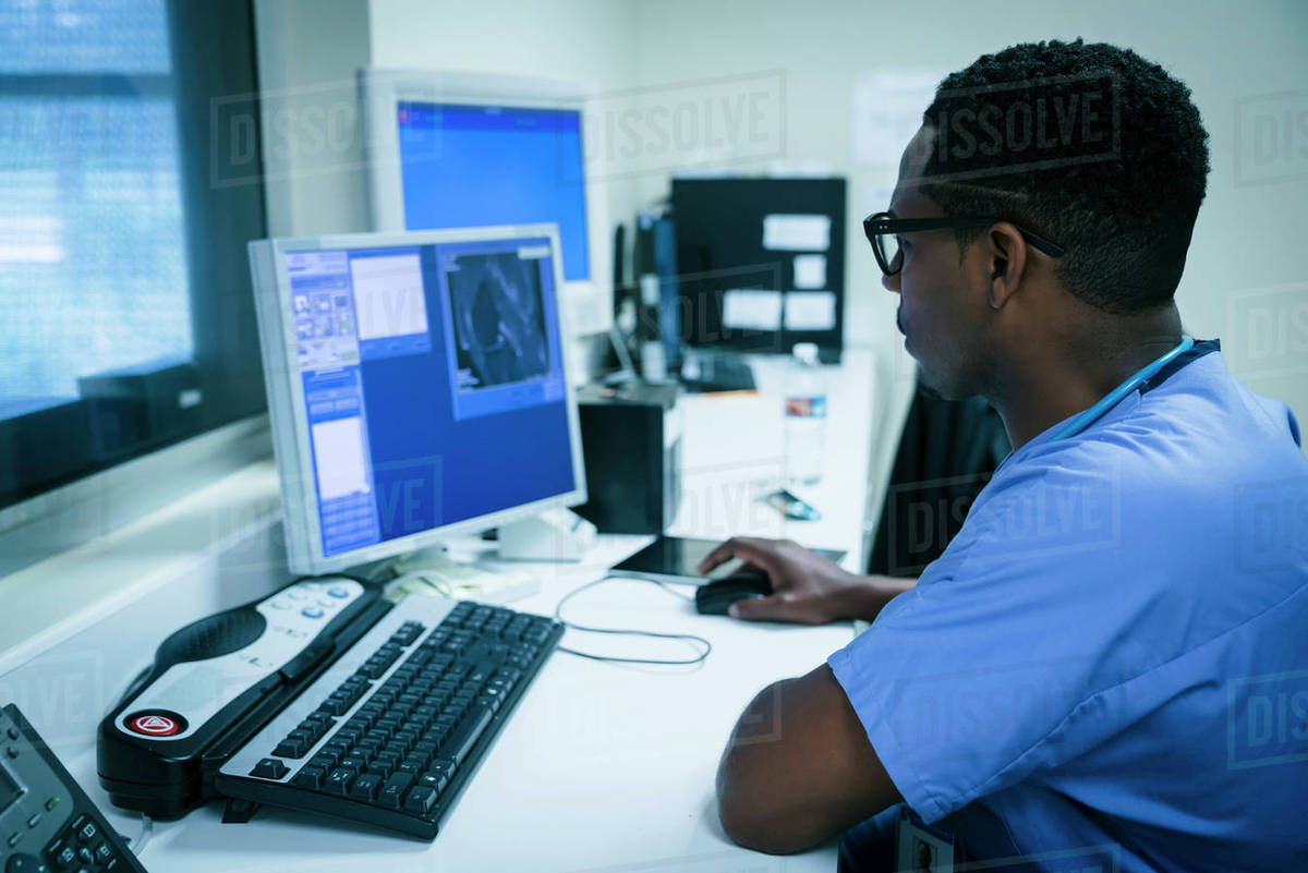 Black nurse using computer - Royalty-free Stock Photo | Dissolve