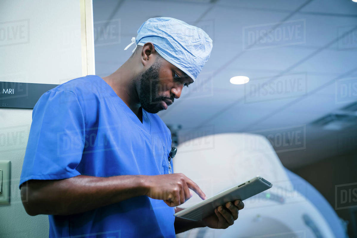 Serious black nurse using digital tablet - Royalty-free Stock Photo ...