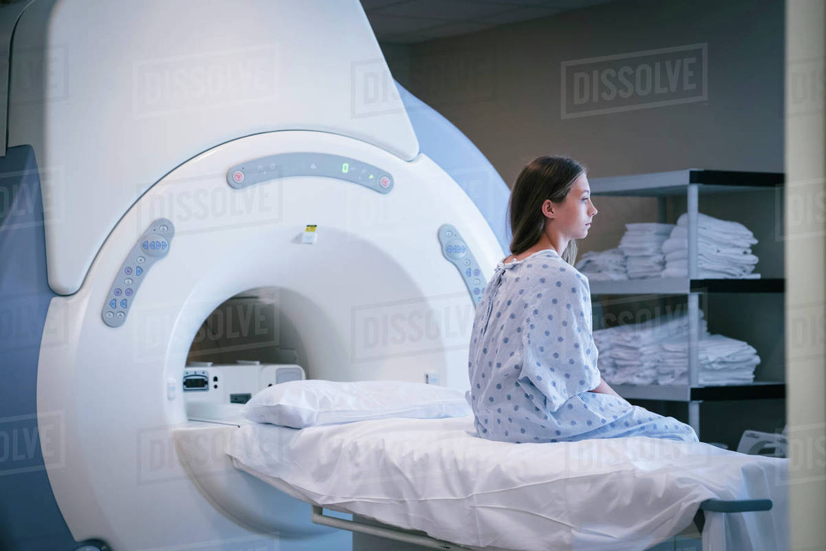 Pensive Caucasian girl sitting on scanner table - Royalty-free Stock ...