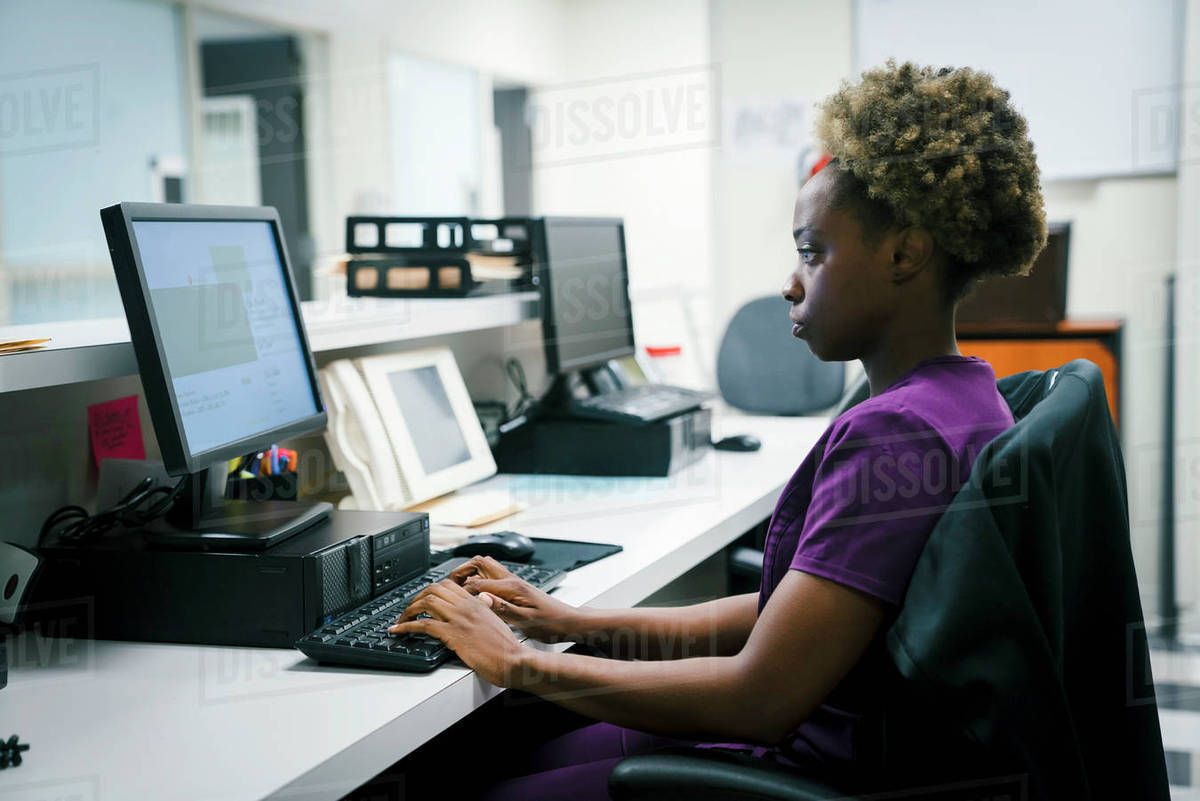 Black nurse using computer - Royalty-free Stock Photo | Dissolve