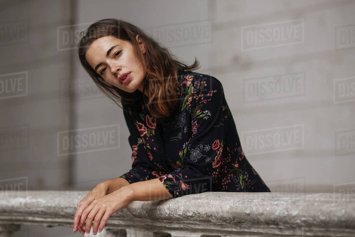 Caucasian woman leaning on railing - Stock Photo - Dissolve