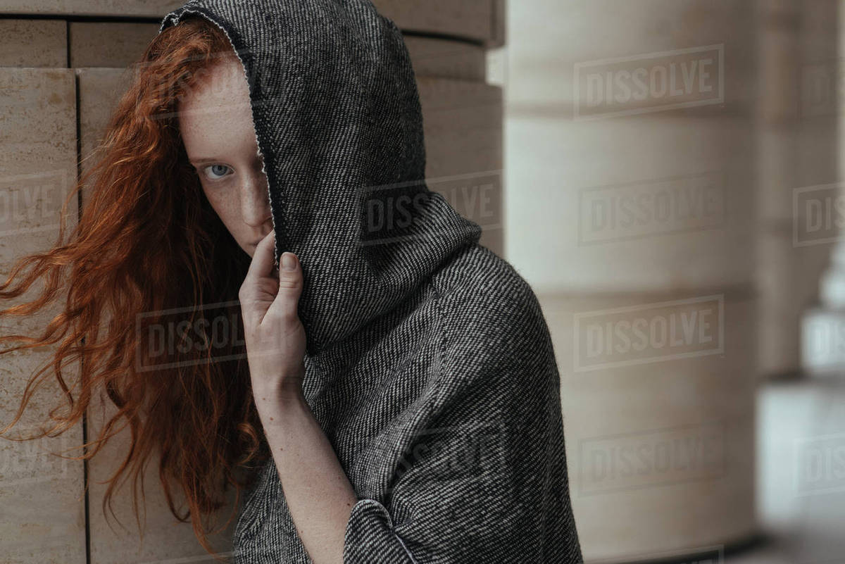 Caucasian woman hiding face behind hood - Royalty-free Stock Photo ...