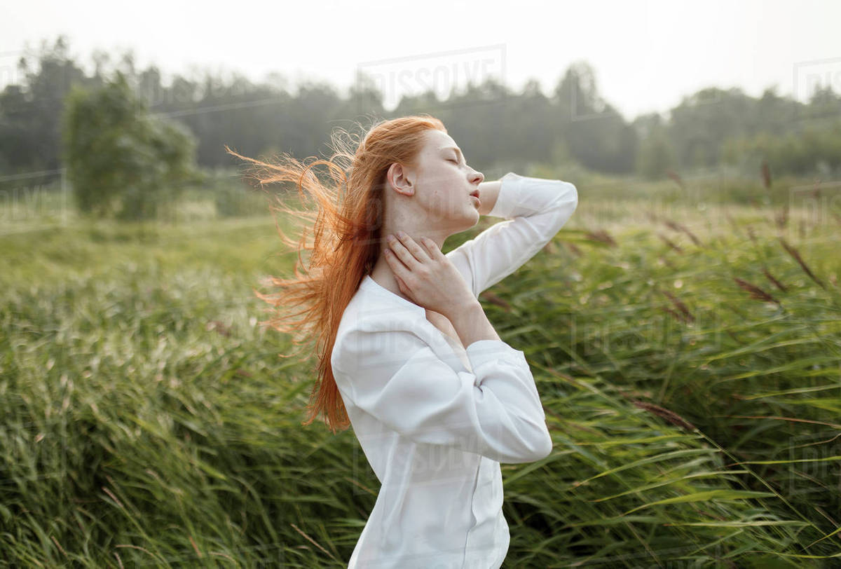 Wind blowing hair of Caucasian woman in field - Royalty-free Stock ...