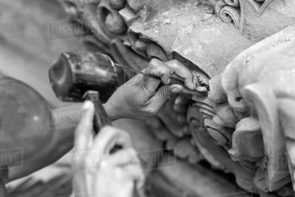 Artisan carving stone statue - Stock Photo - Dissolve
