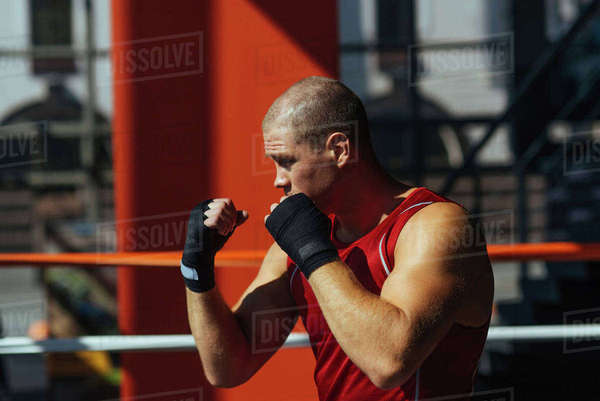 Portrait of Caucasian boxer with fists raised - Stock Photo - Dissolve