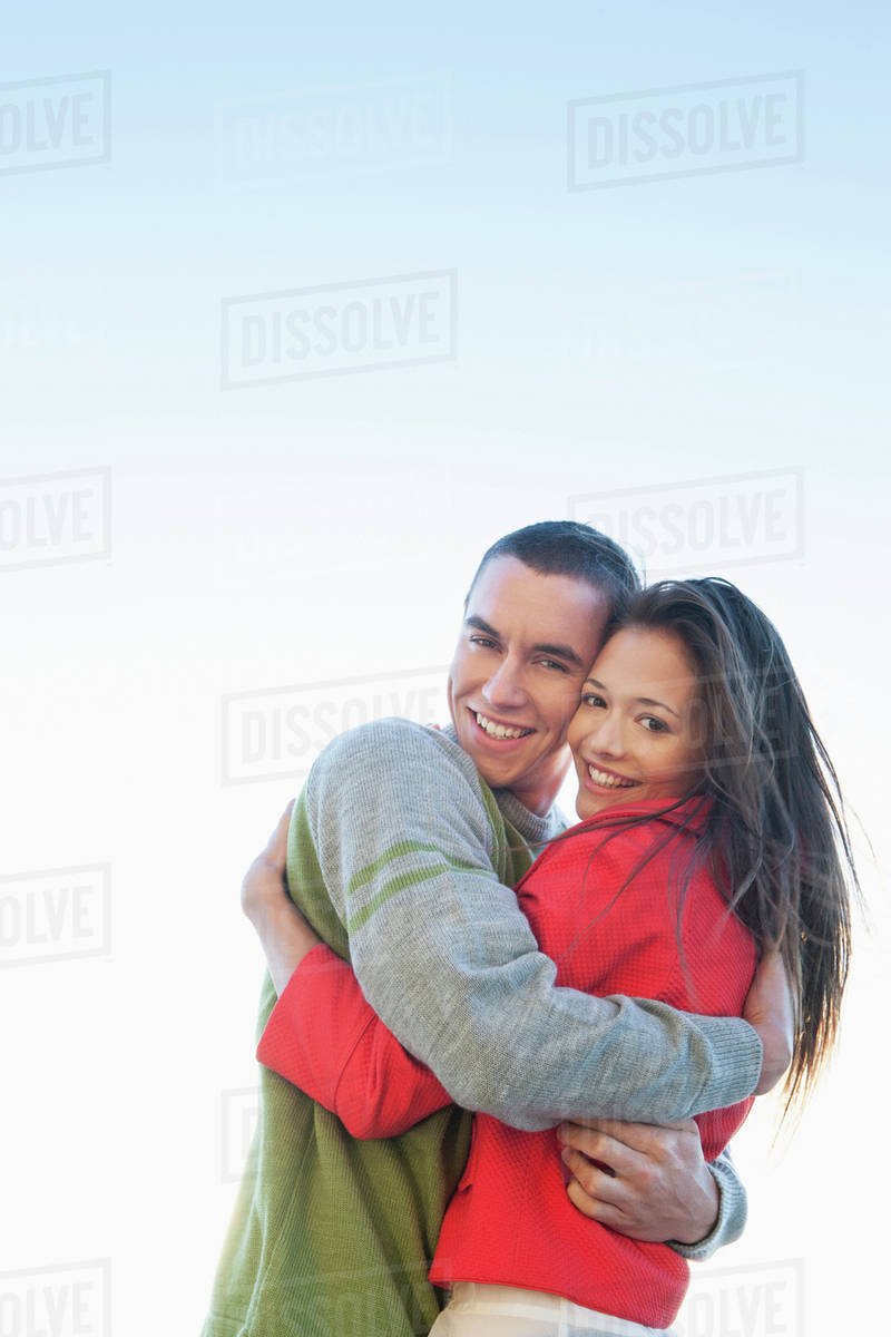 Caucasian couple hugging outdoors - Stock Photo - Dissolve