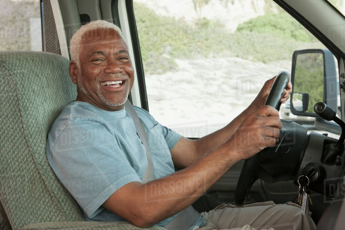 Mixed race Senior man driving RV - Royalty-free Stock Photo | Dissolve
