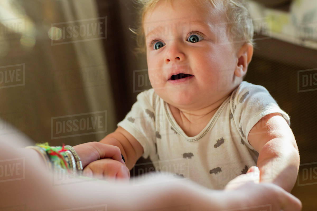 Caucasian baby gasping at mother - Stock Photo - Dissolve