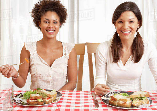 Women eating dinner together - Royalty-free Stock Photo | Dissolve