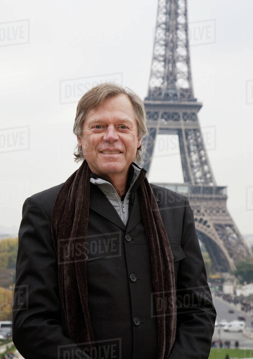 Caucasian man standing in front of Eiffel Tower, Paris, Ile de France ...