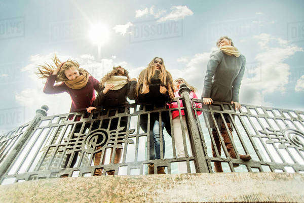 Women leaning over banister - Stock Photo - Dissolve