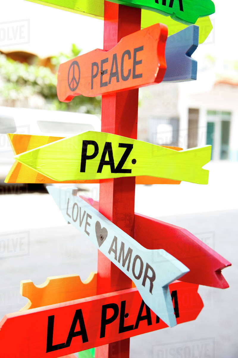 Colorful road signs to Peace and Love - Stock Photo - Dissolve