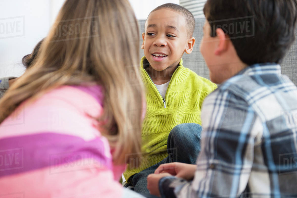 Children talking in living room - Royalty-free Stock Photo | Dissolve