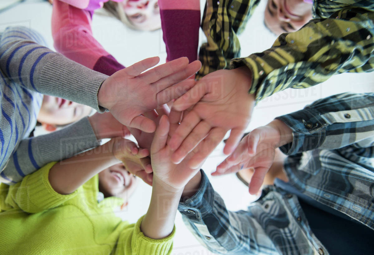 Children cheering in huddle - Royalty-free Stock Photo | Dissolve