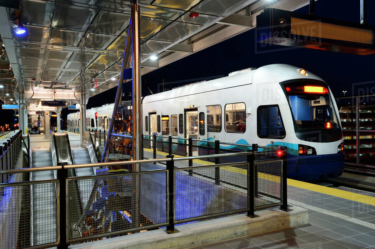 Light rail pulling into station - Stock Photo - Dissolve
