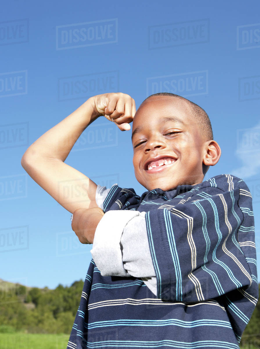 African American boy flexing his muscles - Royalty-free Stock Photo ...