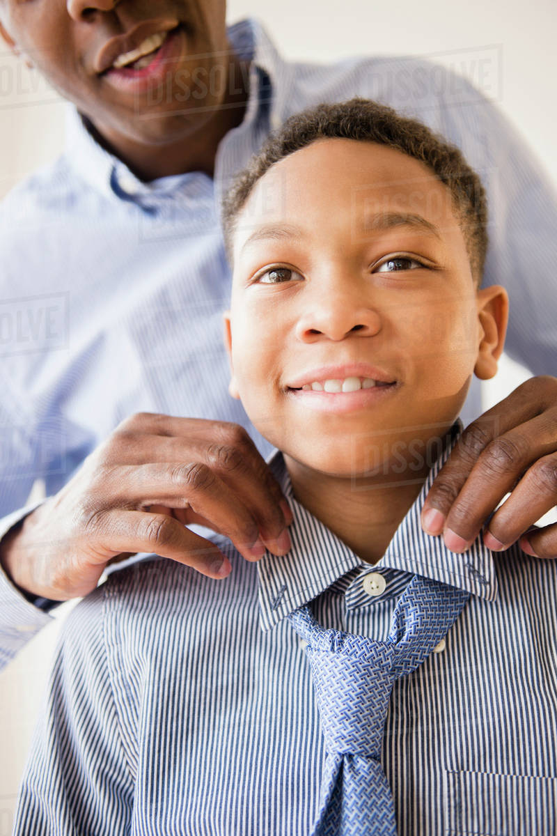 Father adjusting son's tie - Stock Photo - Dissolve